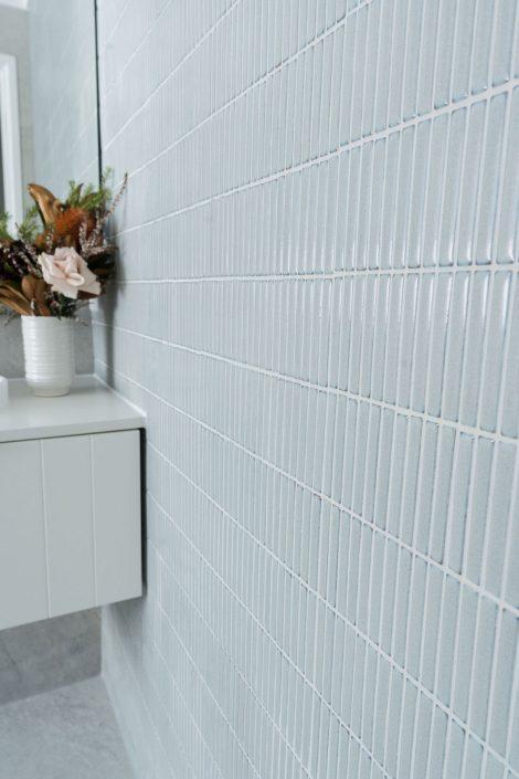 Luxe bathroom renovation featuring grey stone-look tiles and vintage ...